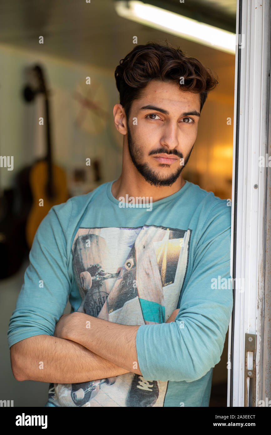 A young Syrian man is seen posing in the doorway of an isobox in Camp ...