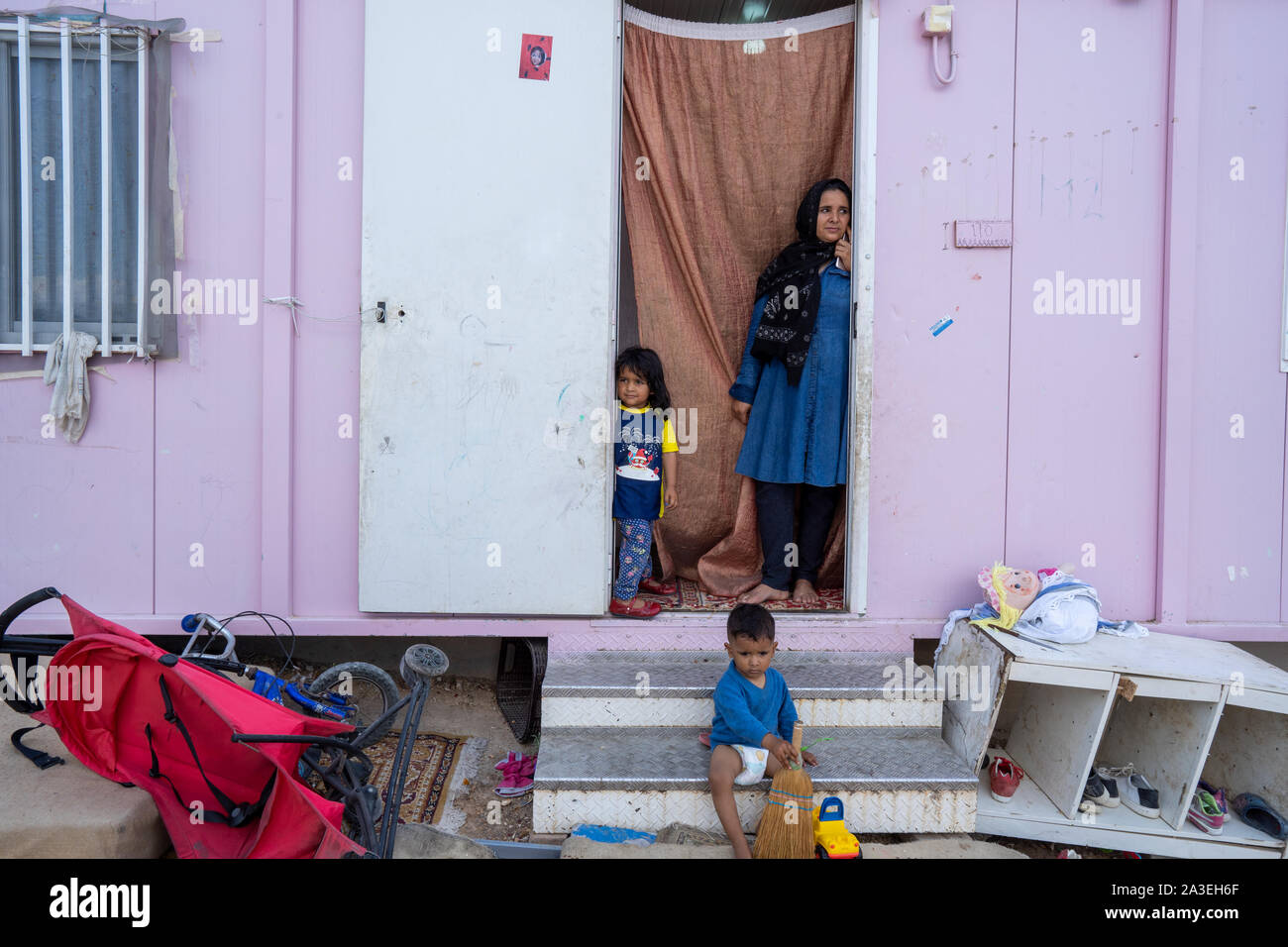 A mother poses with her children in their home in Camp Eleonas in ...