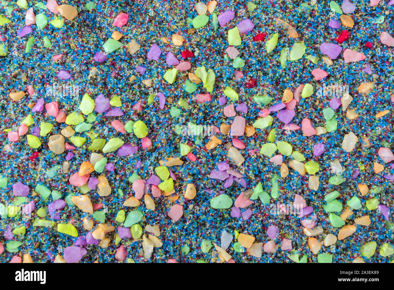 Top view with background of multi-colored small pebbles. Multi-colored ...