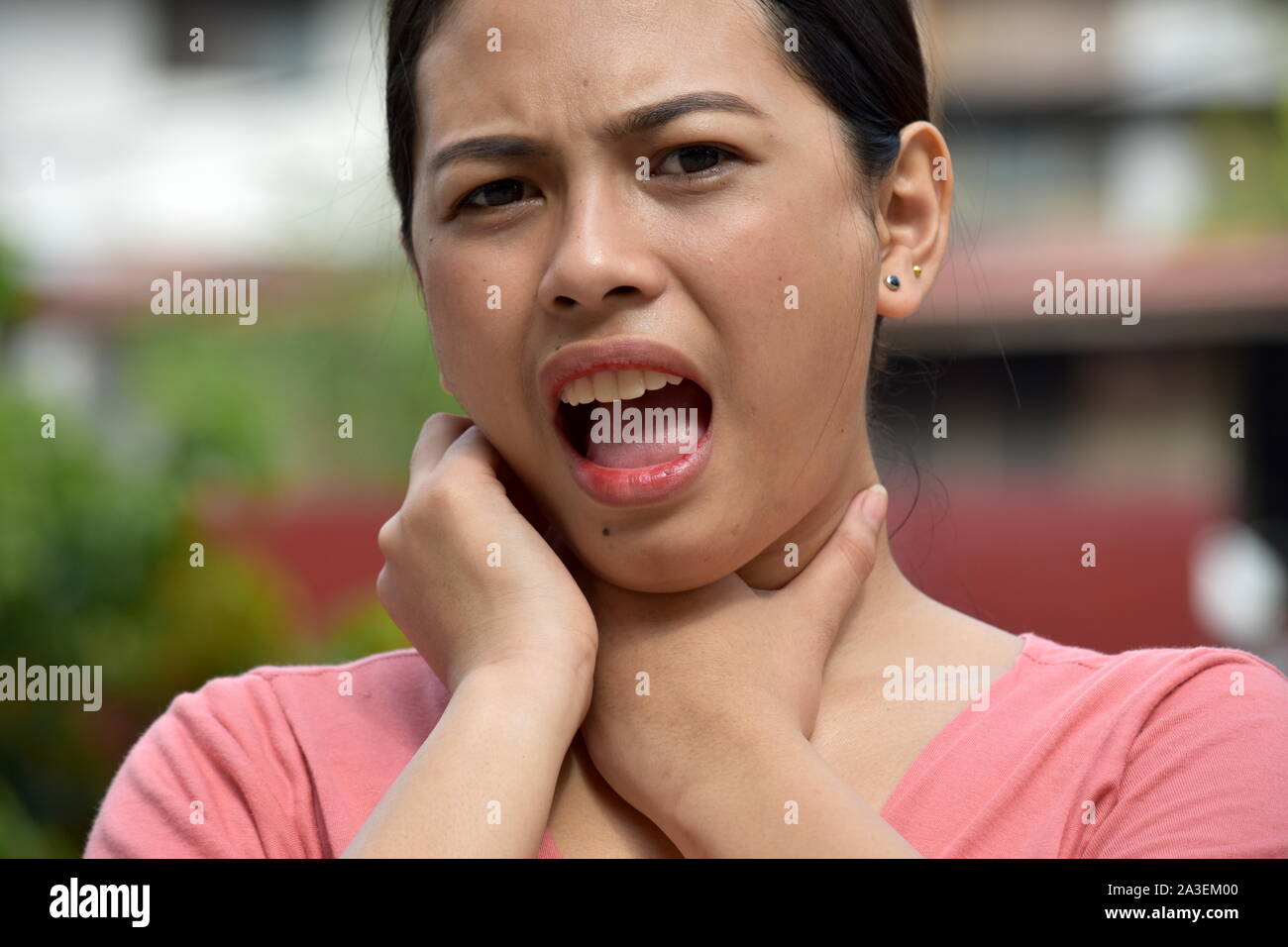 A Choking Attractive Diverse Female Stock Photo - Alamy