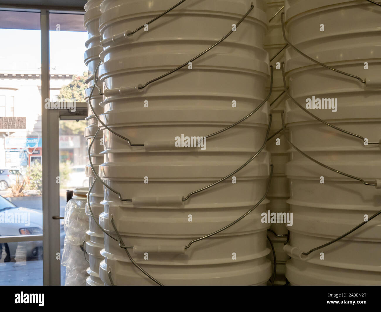 Tall stack of clean white buckets in home improvement store Stock Photo ...