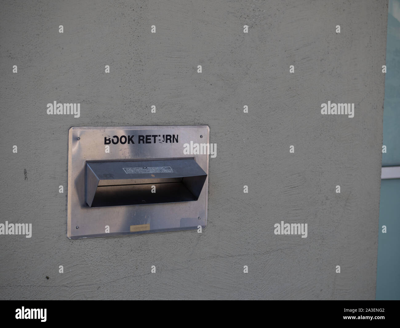 Book return metal slot outside of a public library building Stock Photo ...