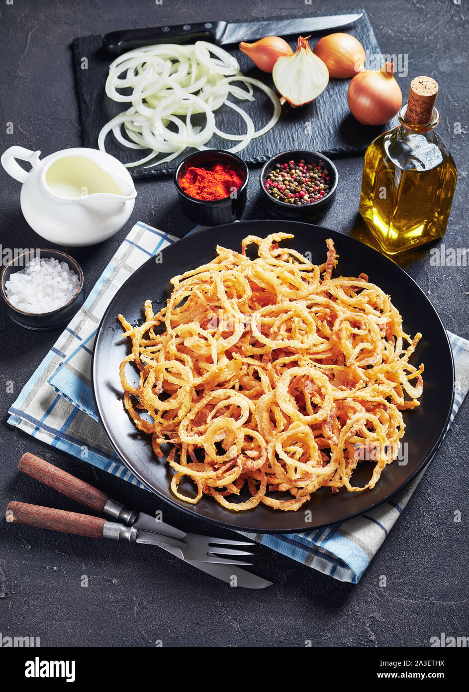french crispy fried onion rings and strings with crunchy coating on a ...