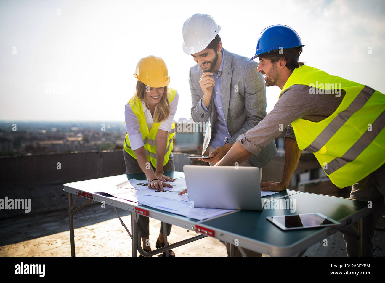 Team of architects people in group on construciton site check documents ...