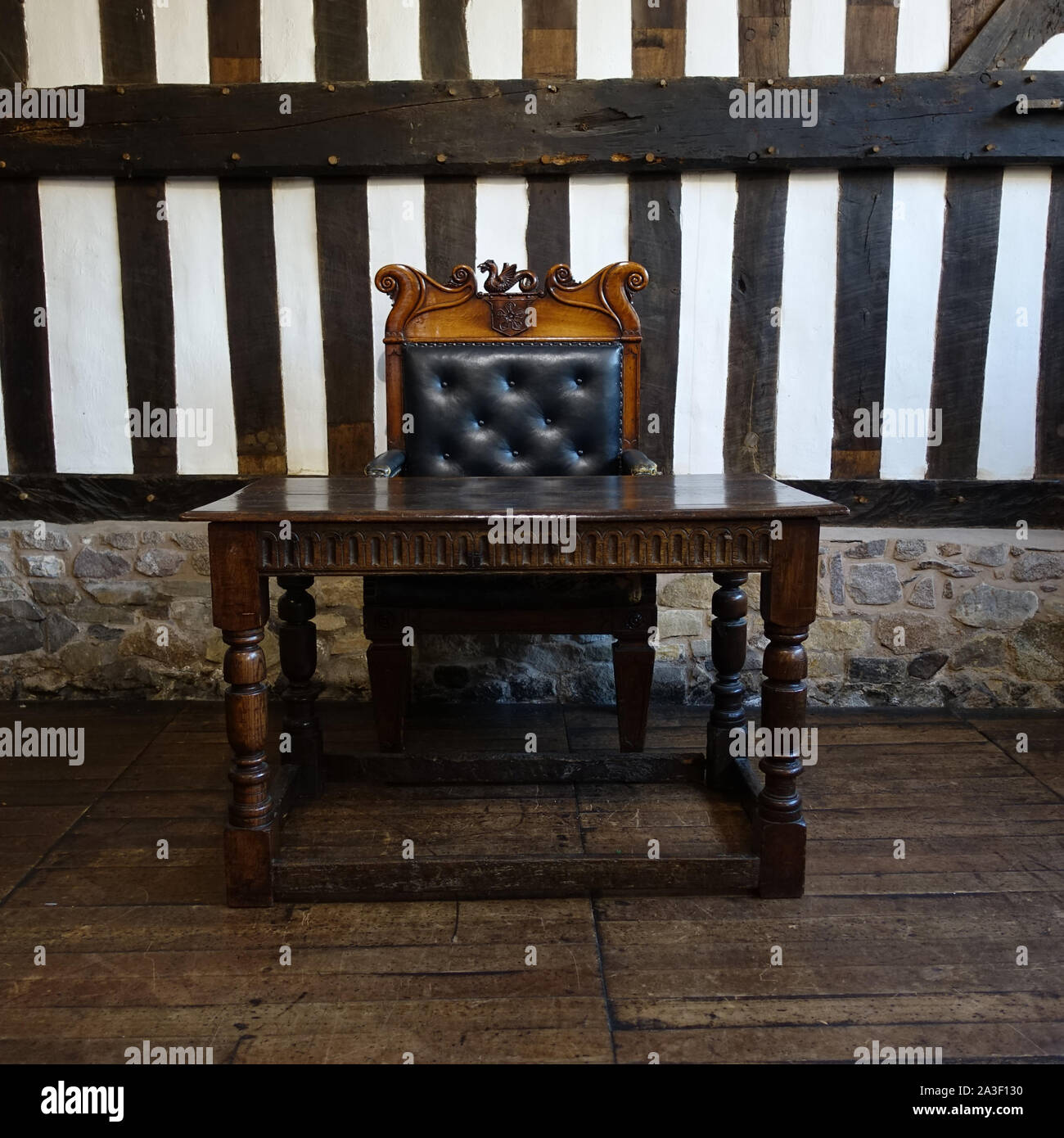 Old wooden table and leather chair in the Great Hall of Leicester ...