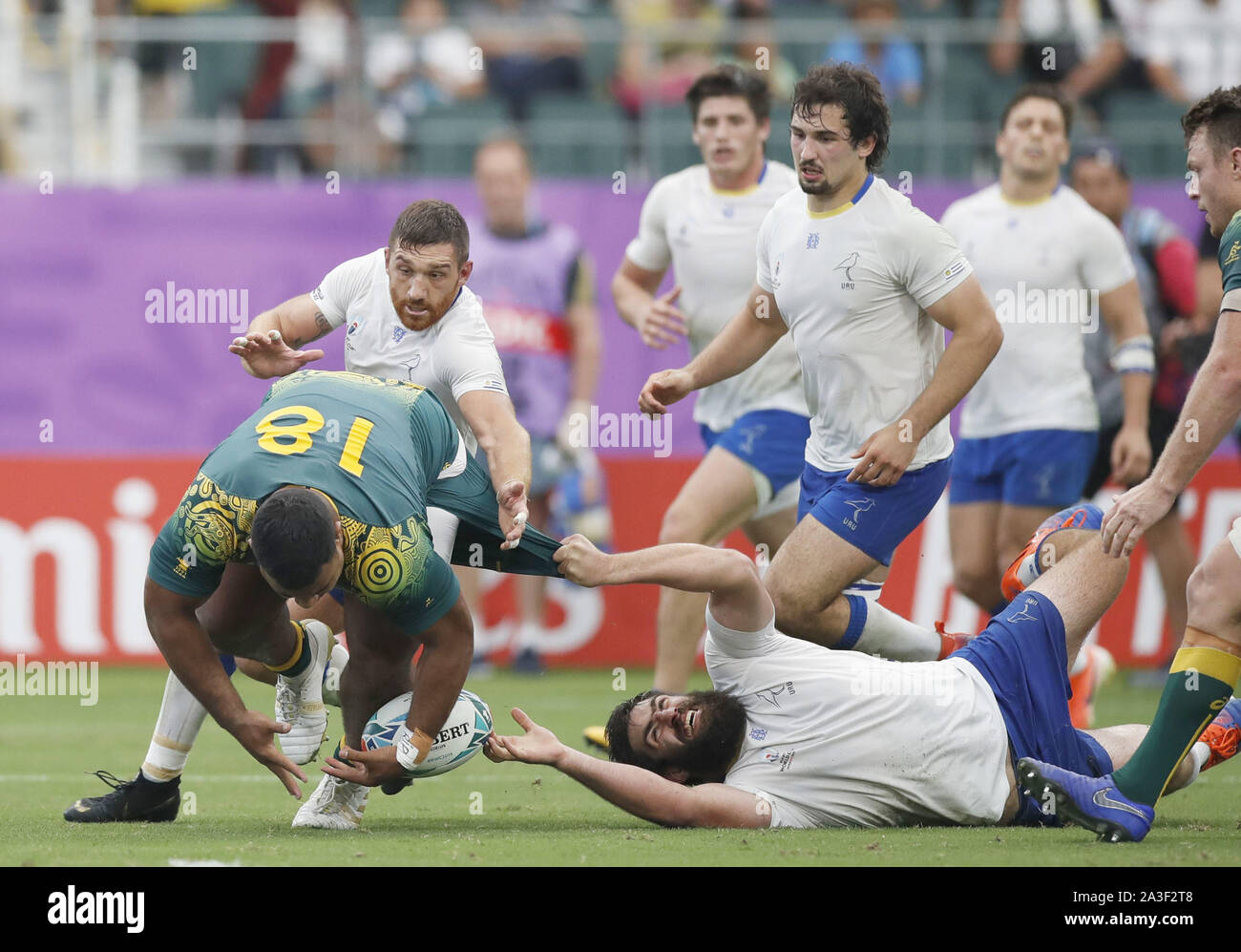 Diego Arbelo (R) of Uruguay tries to stop Taniela Tupou (18) of ...