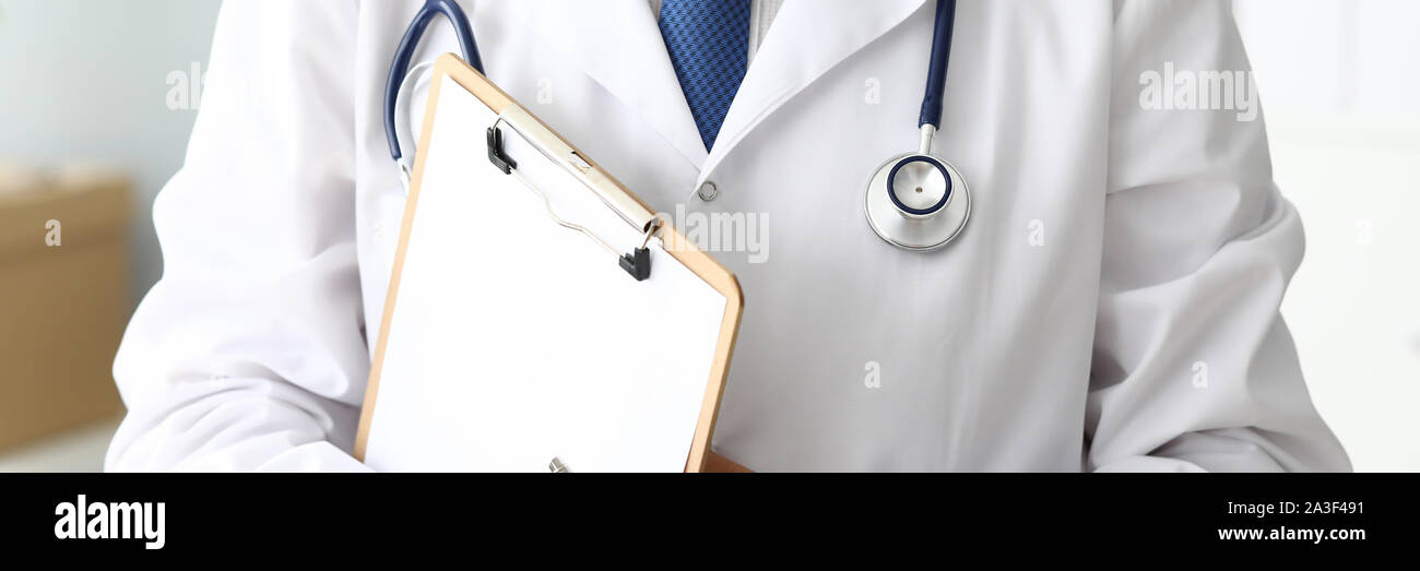 Doctor holding medical clipboard Stock Photo - Alamy