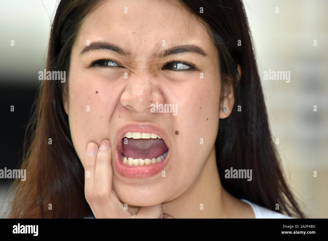 Young Minority Adult Female With Toothache Stock Photo - Alamy