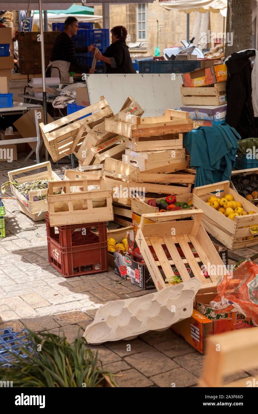Behind the stall of a French vegatable market stall with various fruits ...