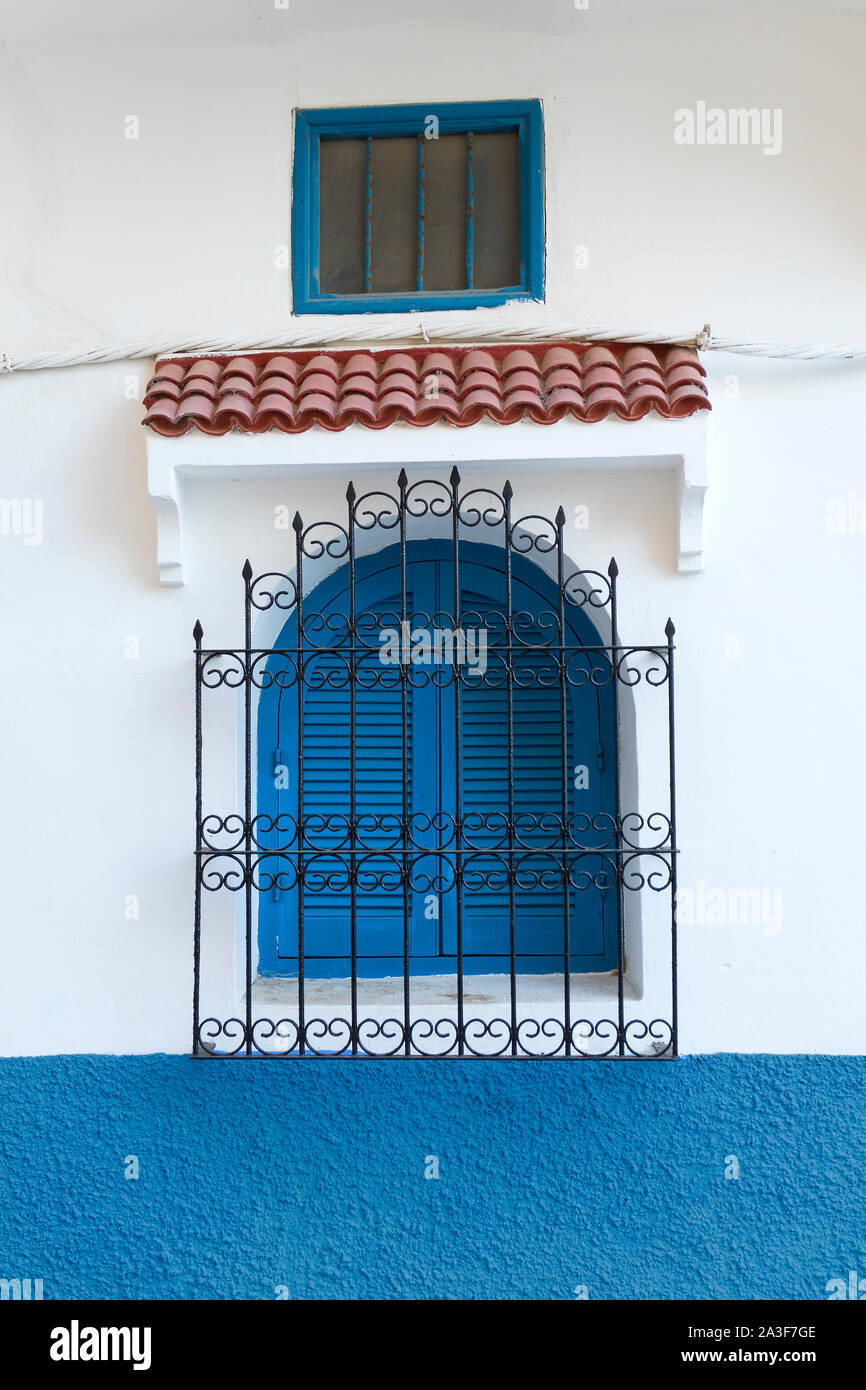 Traditional Moroccan window protected with blue shutters and metal ...