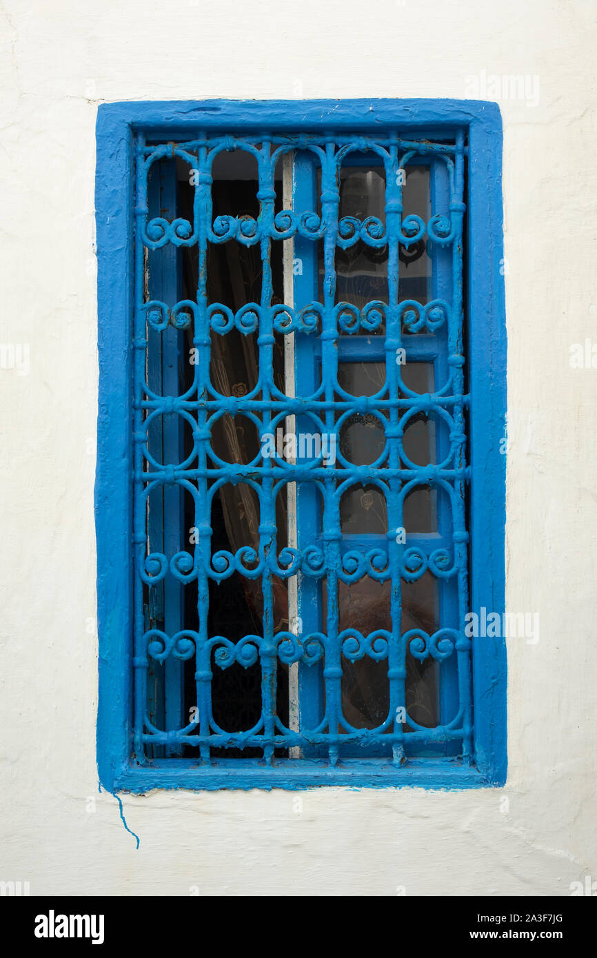Traditional Moroccan window protected with a blue metal railing in ...