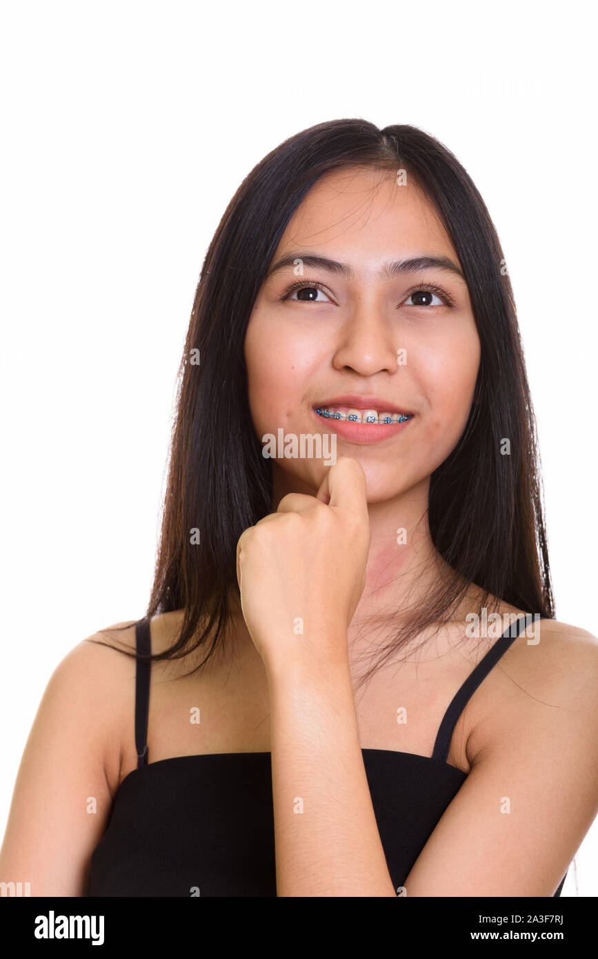 Close up of young happy Asian teenage girl smiling while thinki Stock ...