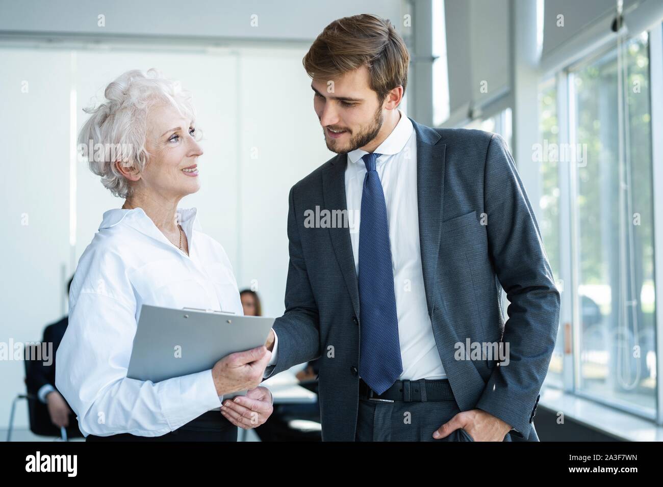 Senior mature caucasian female executive ceo discuss report with young ...