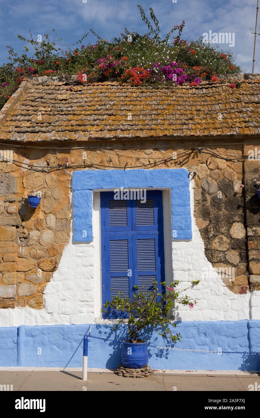 Traditional Moroccan window protected with blue shutters in Assilah ...