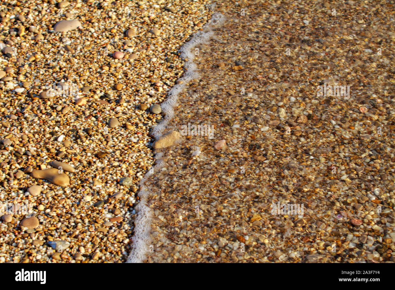sea pebbles colored granite on the beach background stones. The shore ...