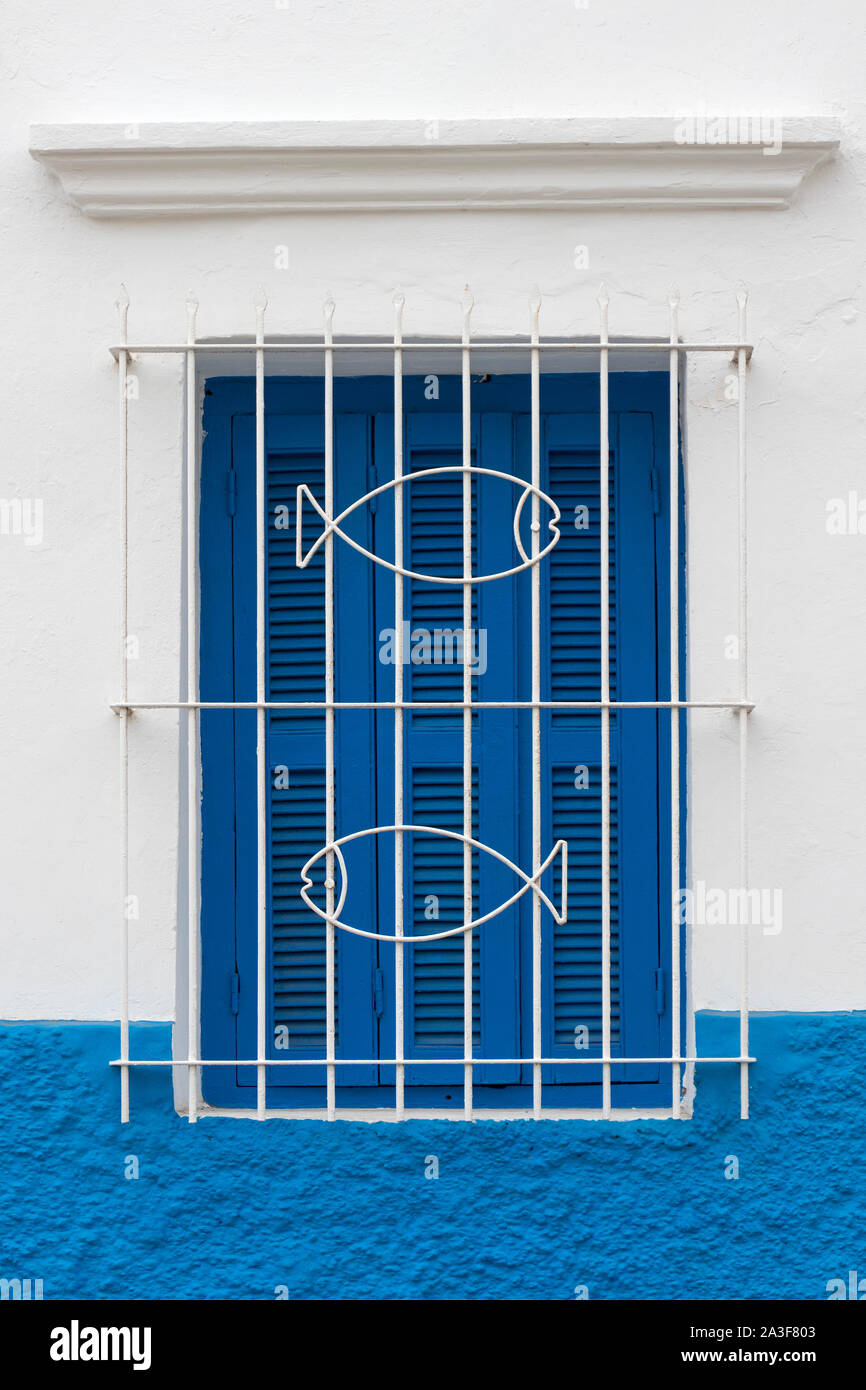 Traditional Moroccan window protected with blue shutters and metal ...
