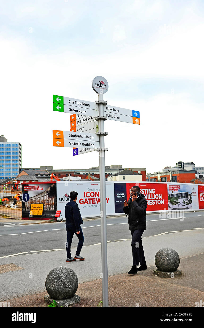 Pedestrians walking in opposite direction next to UCLAN campus ...