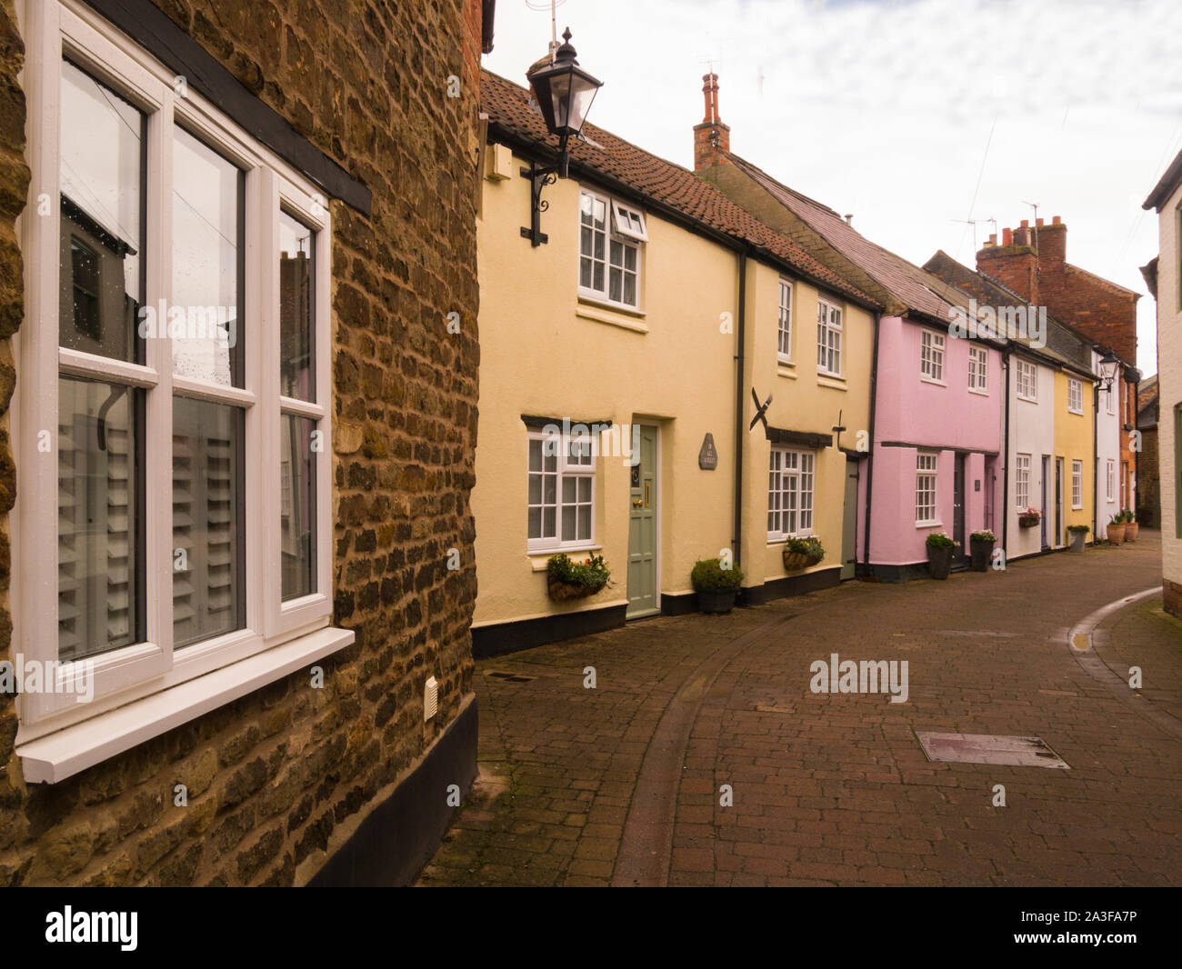 Row of colour washed terraced houses in Oakham County town of Rutland ...