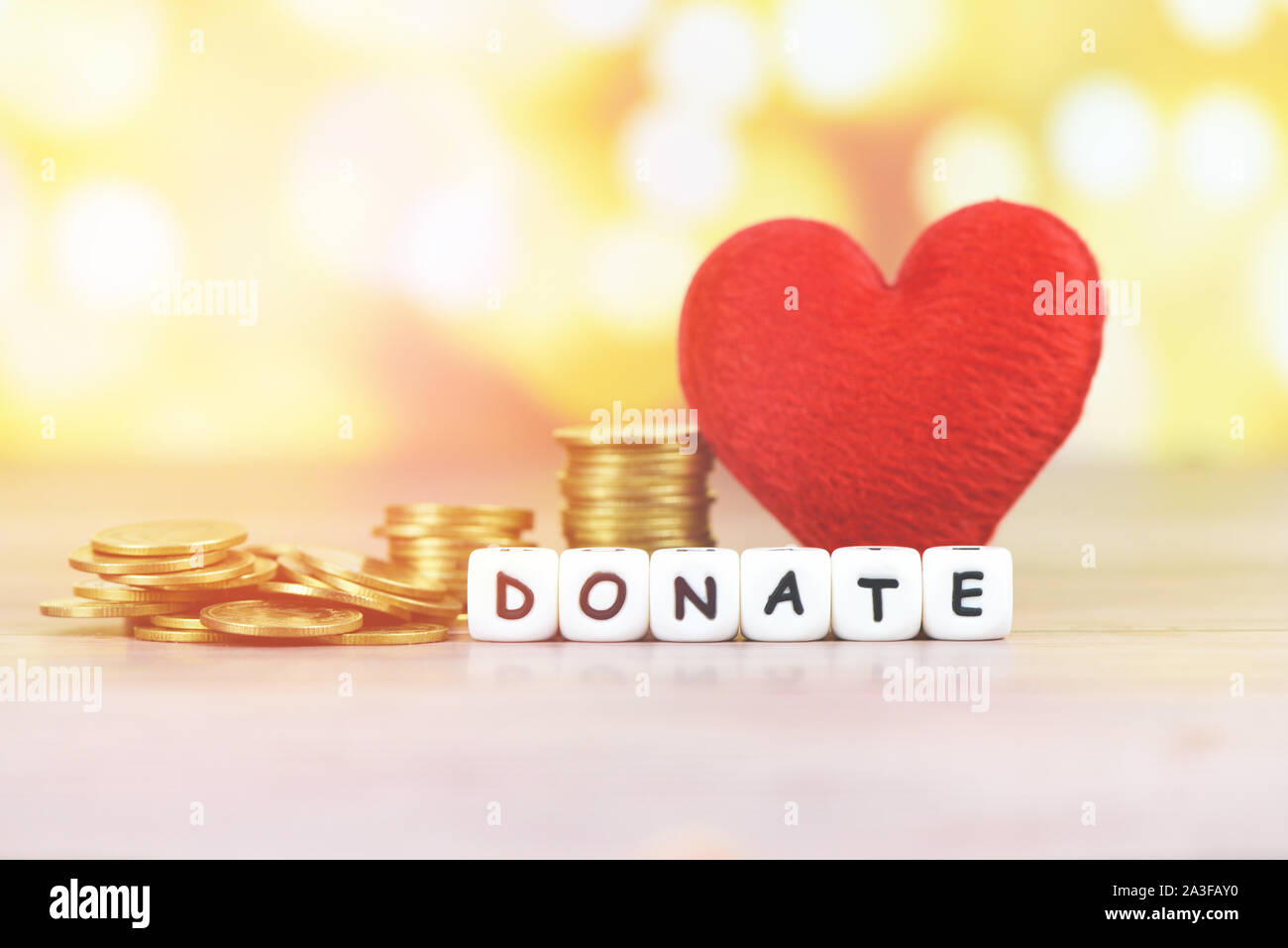 Hand holding heart coins hi-res stock photography and images - Alamy