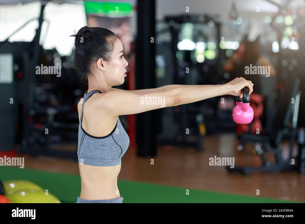 Fitness woman exercise with Kettlebell in gym Stock Photo - Alamy