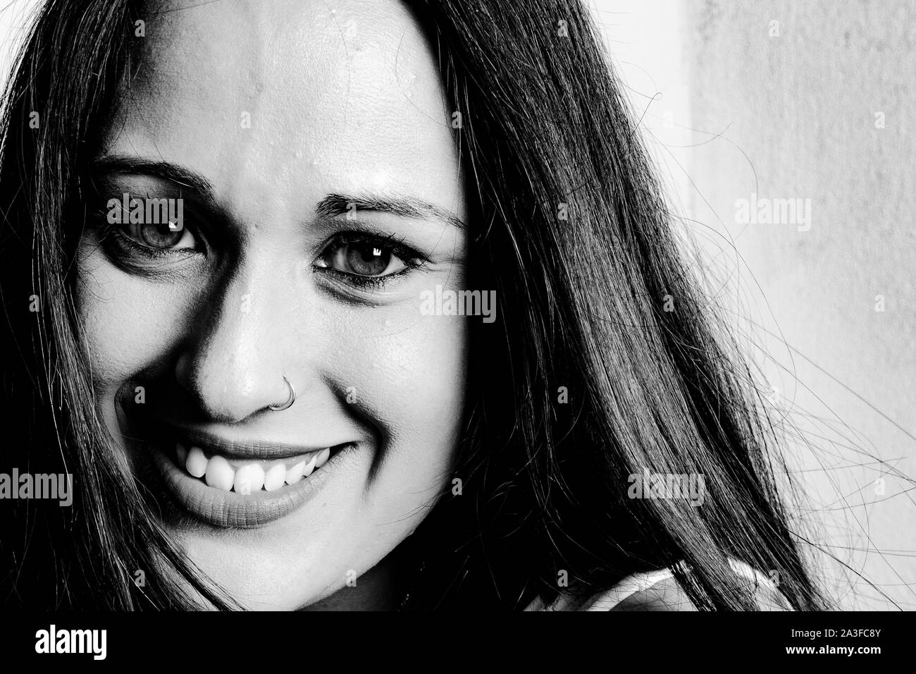 studio lighting portrait of a young woman smiling with expressive eyes ...