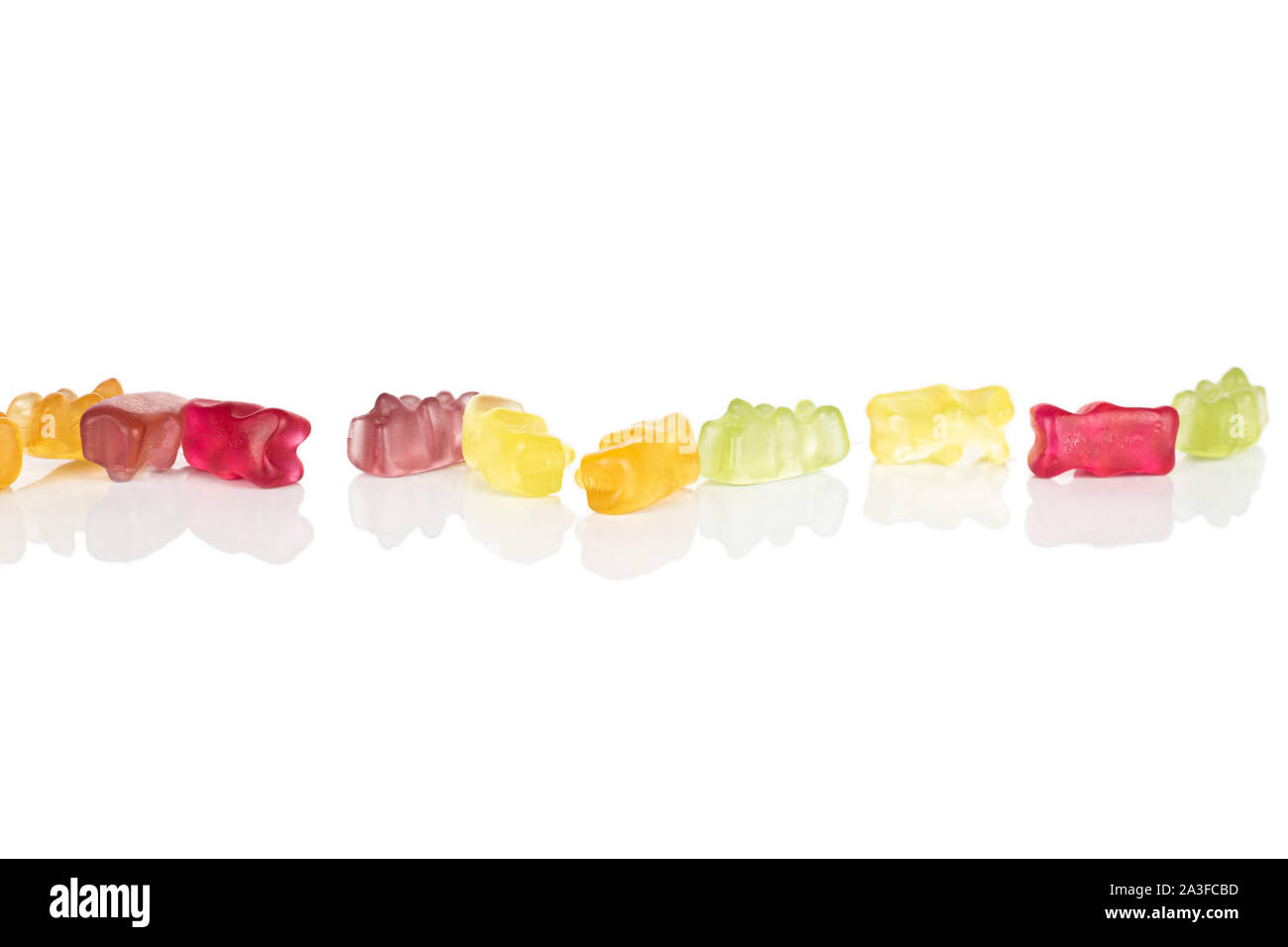 Lot of whole gummy bear in row isolated on white background Stock Photo ...