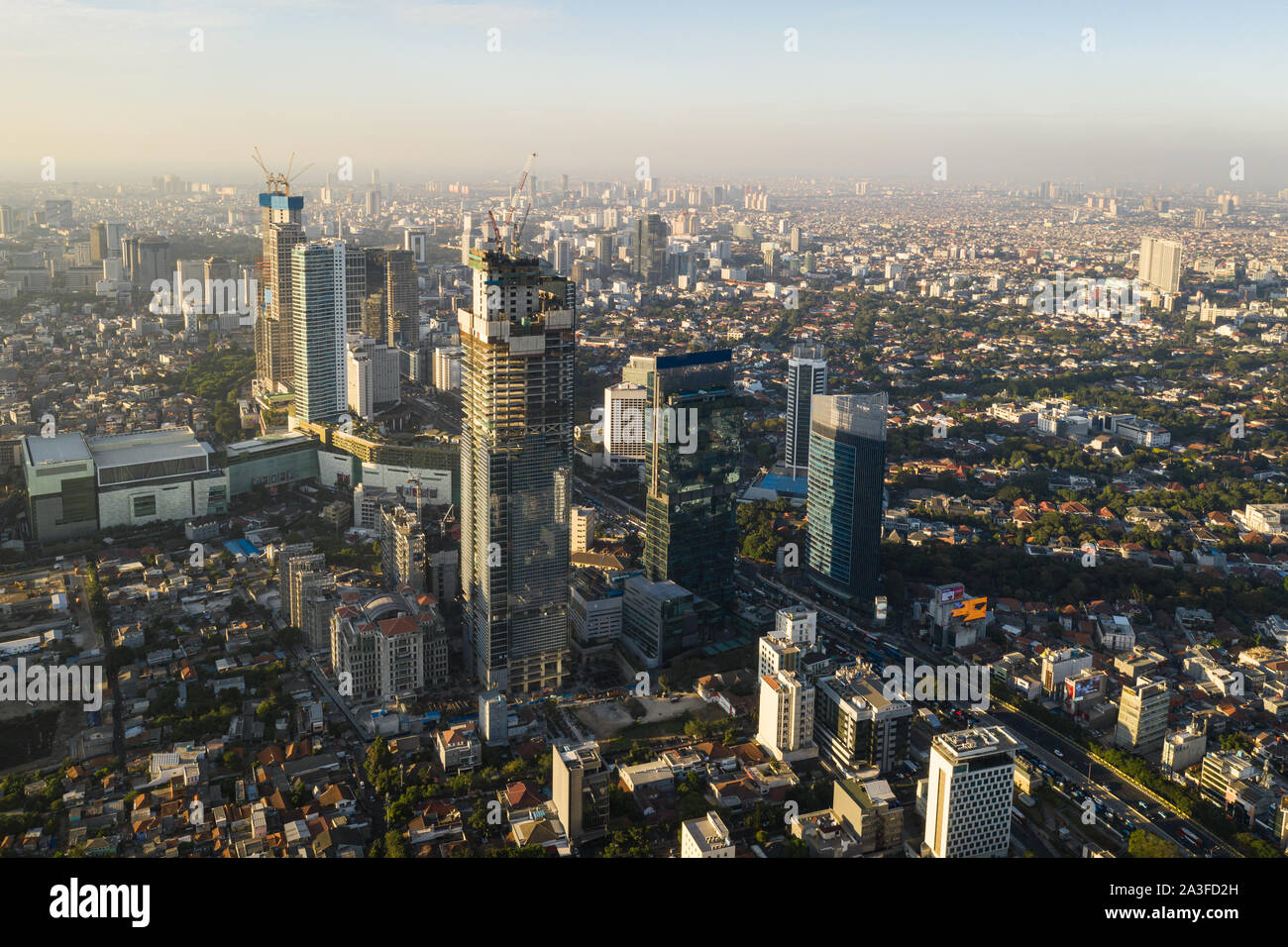 Modern skyscraper in construction in the heart of Jakarta business ...