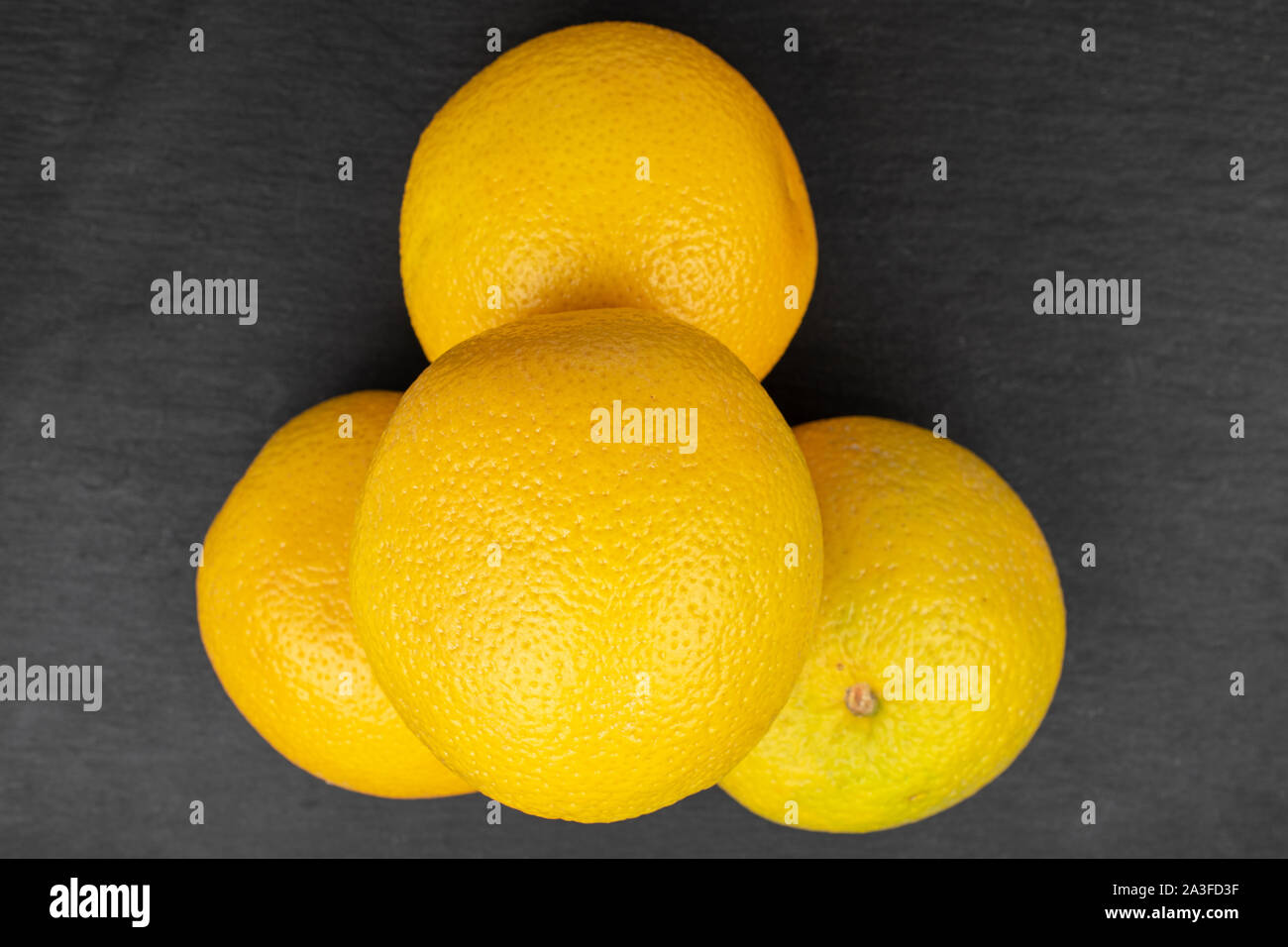 Group of four whole fresh bright orange flatlay on grey stone Stock ...