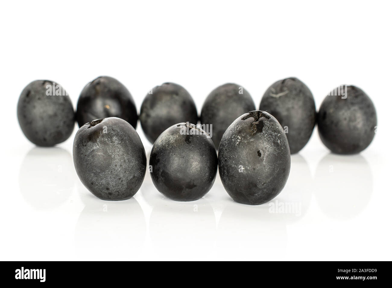 Group of nine whole tasty black olive isolated on white background ...