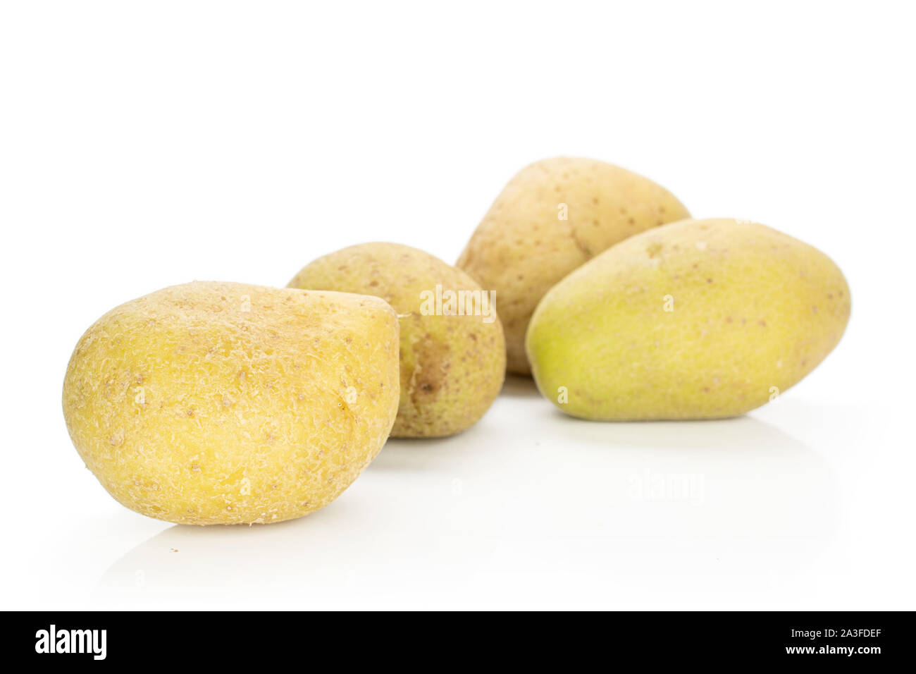 Group of four whole raw brown potato isolated on white background Stock ...
