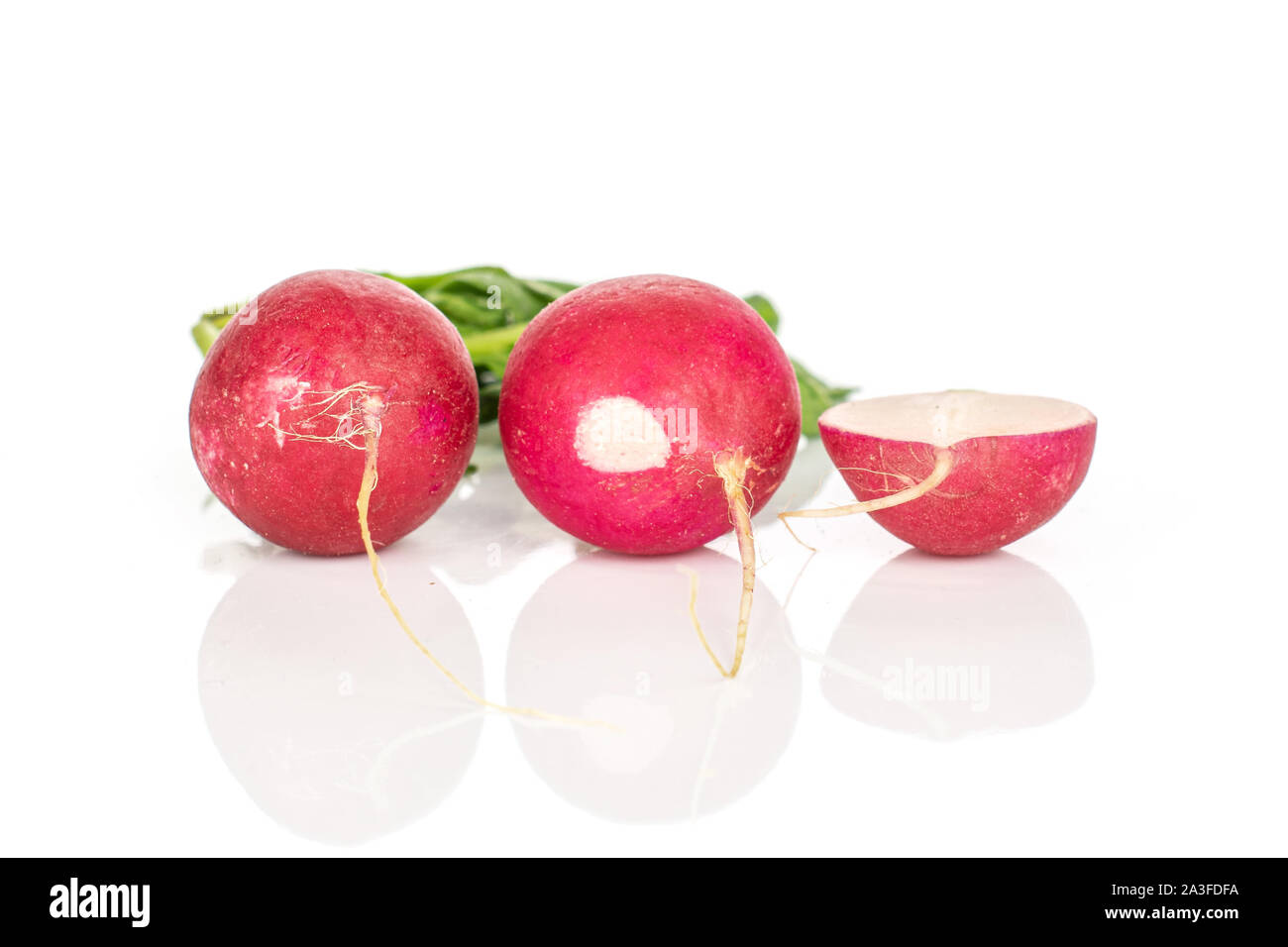Group of two whole one half of fresh red radish isolated on white ...