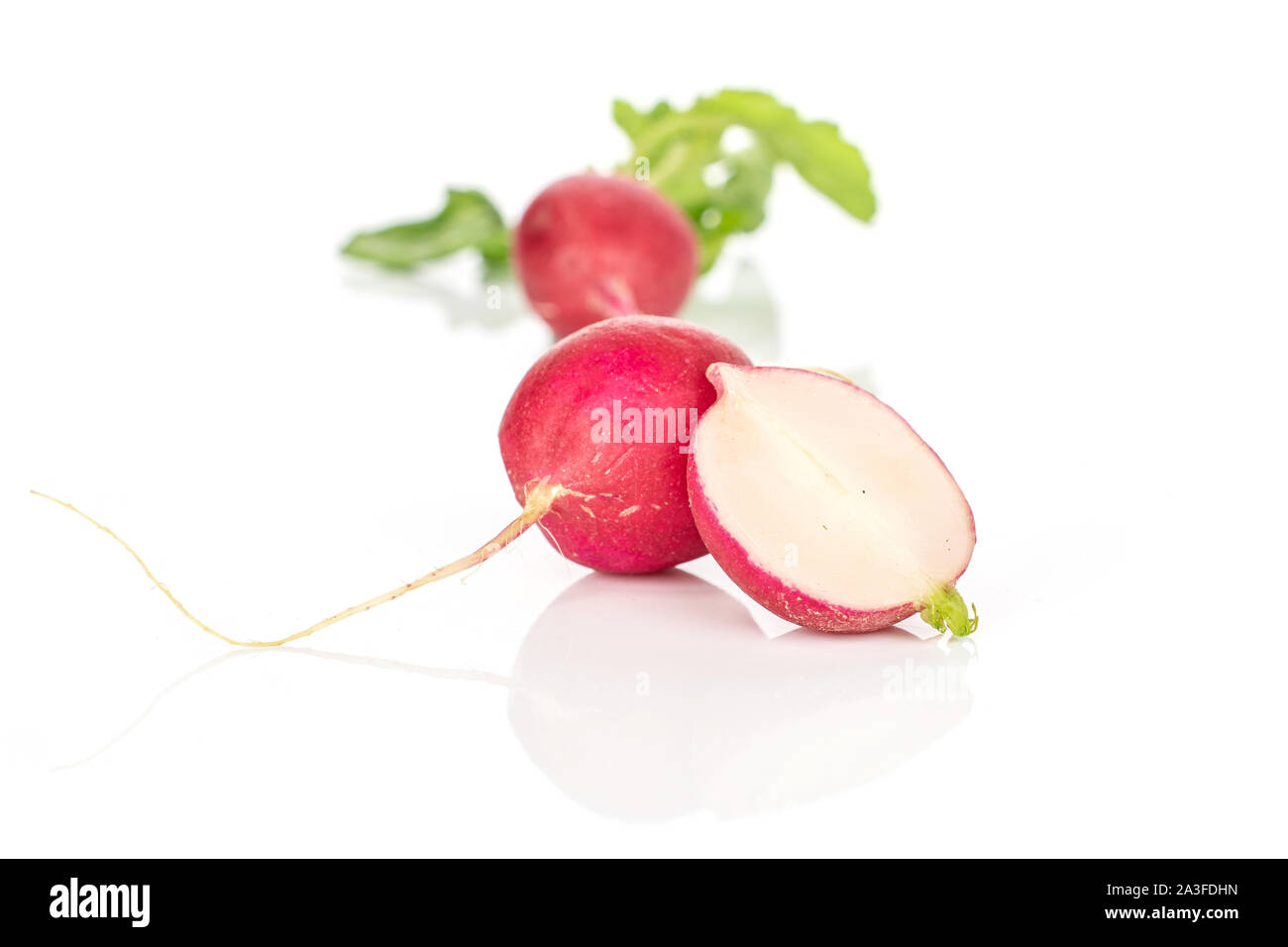 Group of two whole one half of fresh red radish isolated on white ...