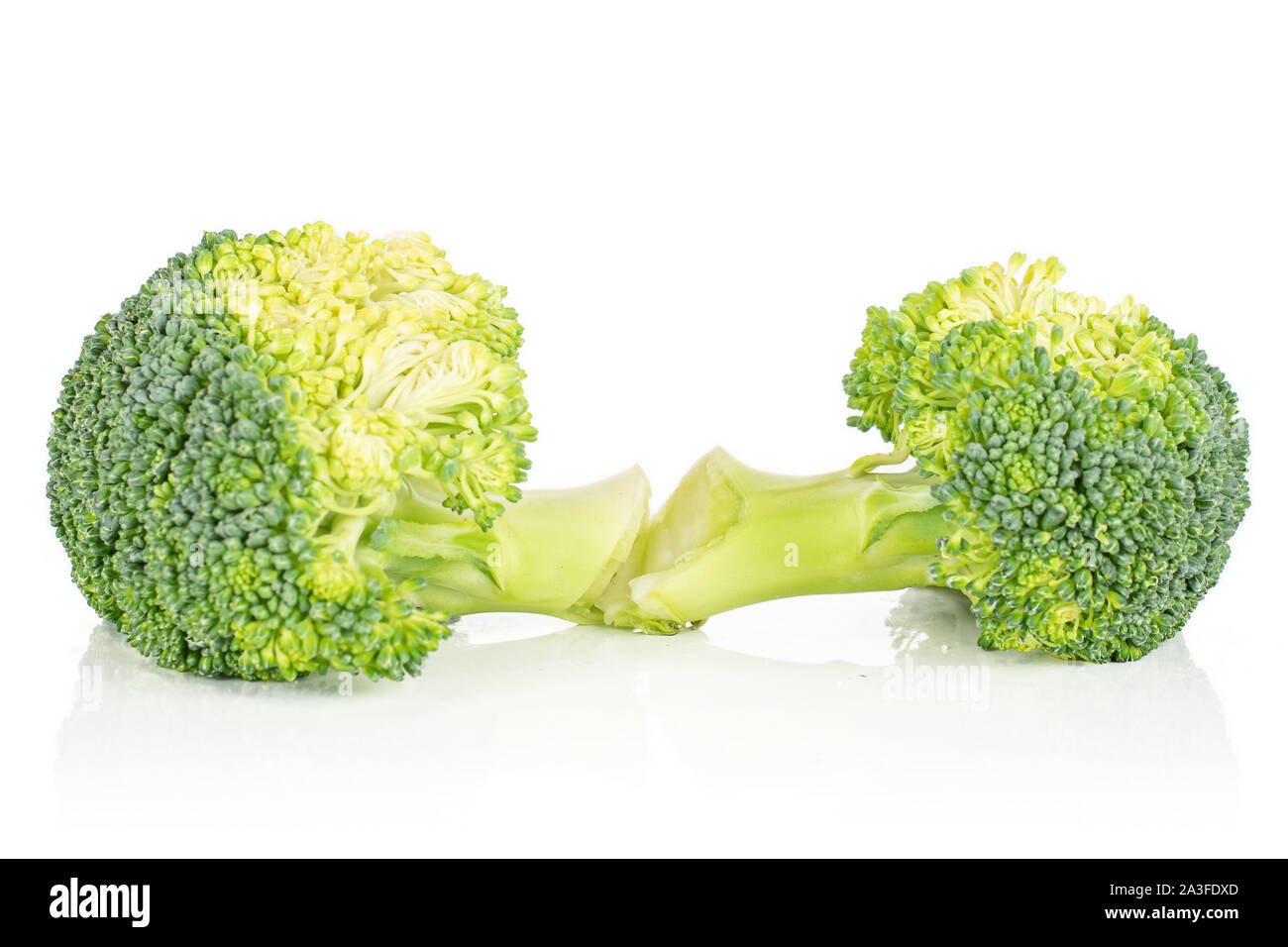 Group of two whole arranged fresh green broccoli isolated on white ...