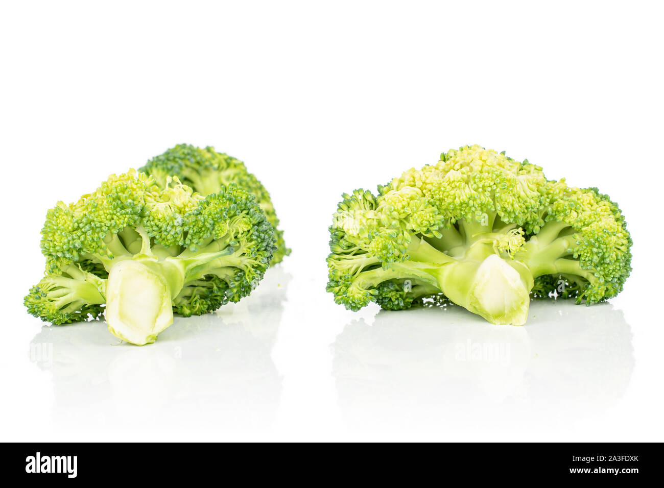 Group of two whole arranged fresh green broccoli isolated on white ...