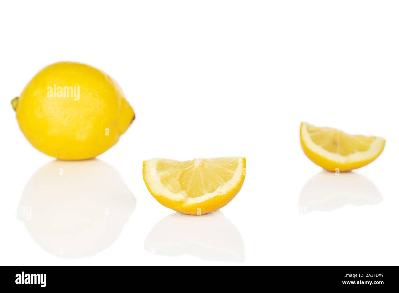 Group of one whole two quarters of fresh yellow lemon isolated on white ...
