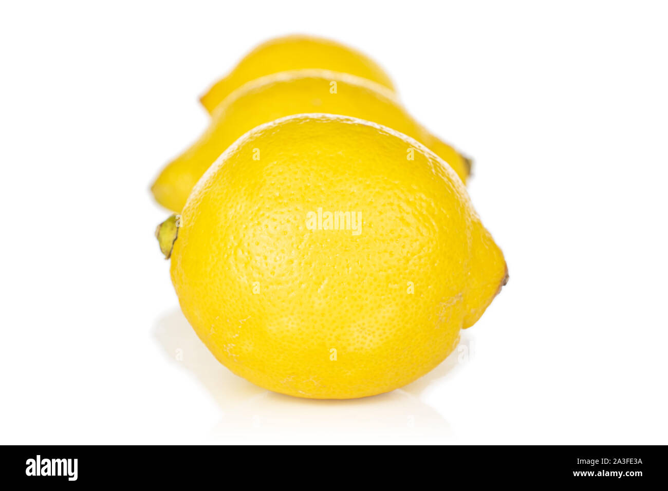 Group of three whole fresh yellow lemon in row isolated on white ...