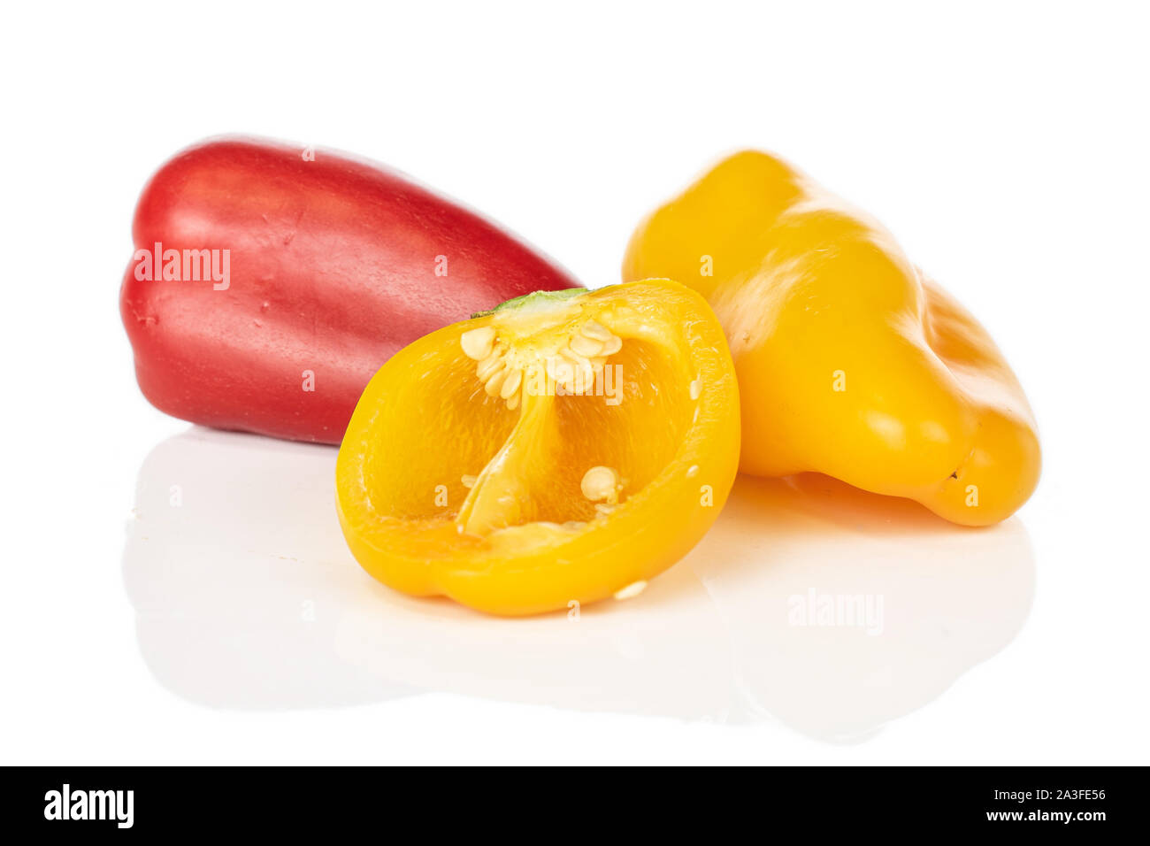 Group of two whole one half of fresh pepper isolated on white ...