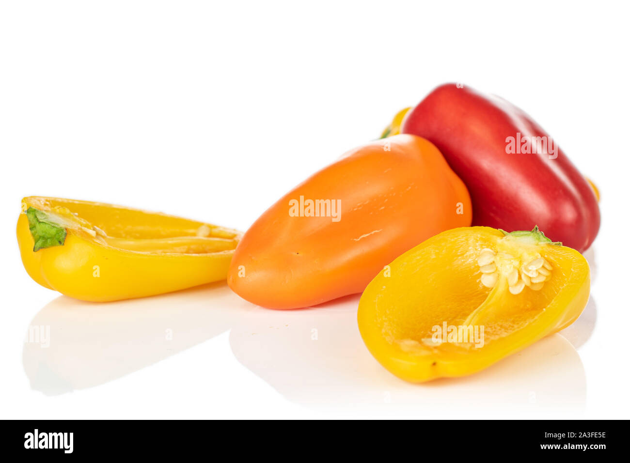 Group of three whole one half of fresh pepper isolated on white ...