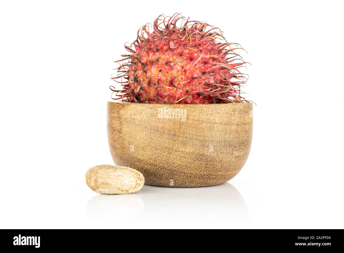 Group of one whole one piece of unpeeled fresh red rambutan in wooden ...