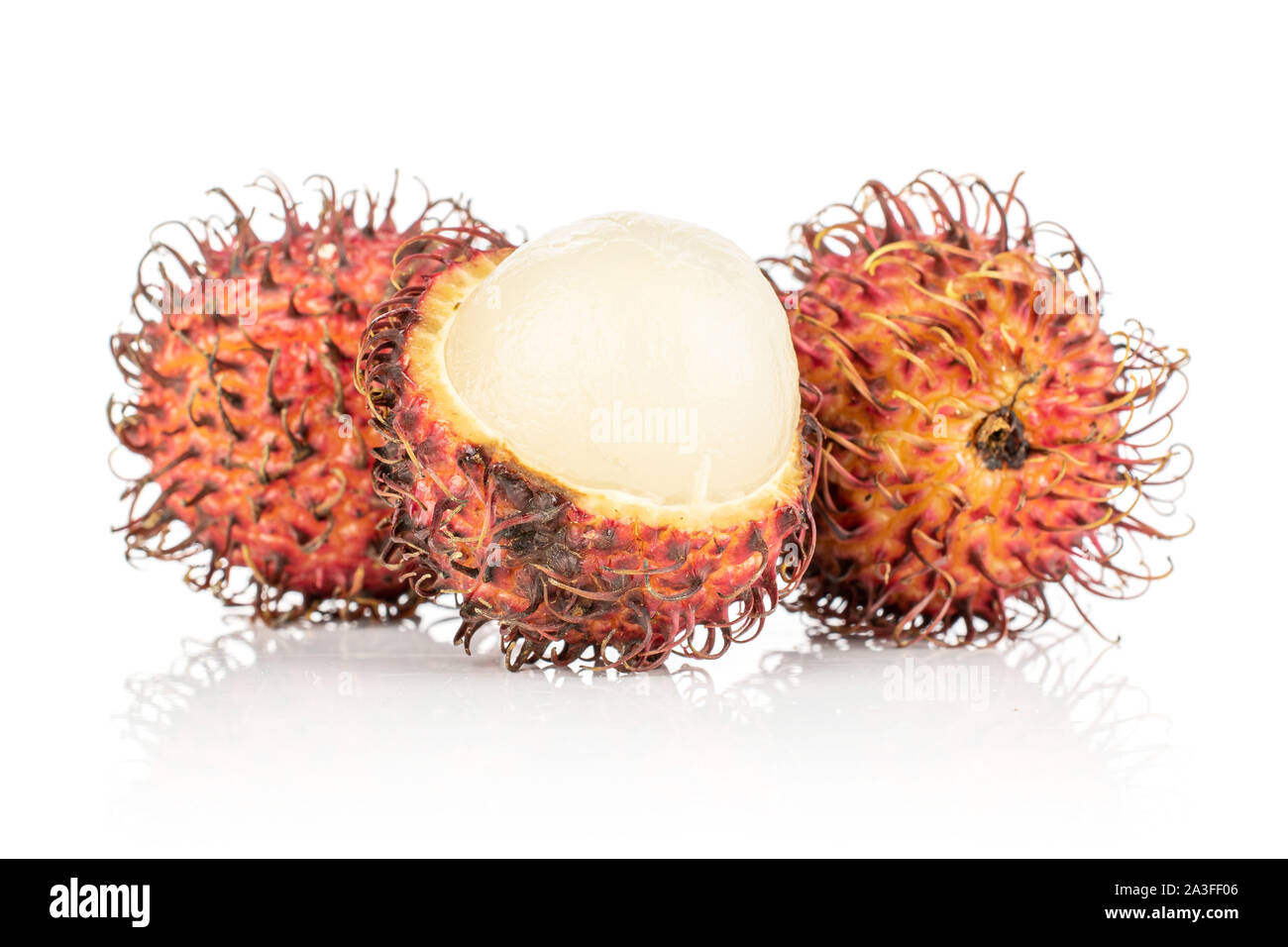 Group of two whole one half of fresh red rambutan isolated on white ...