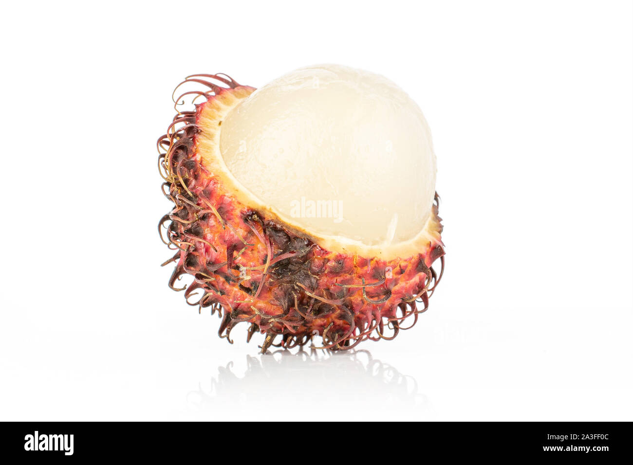 One half of open fresh red rambutan isolated on white background Stock ...