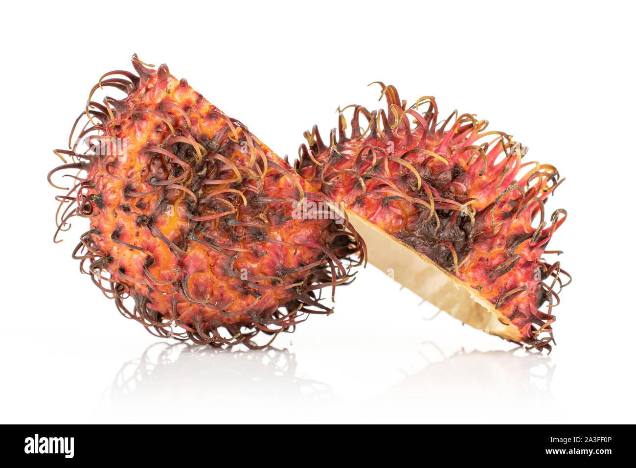 Group of two halves of fresh red rambutan one sliced skin isolated on ...