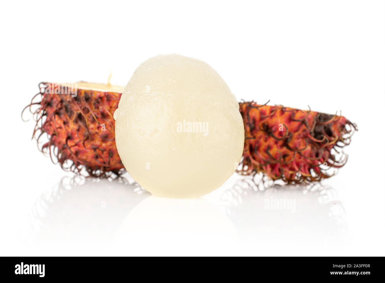 Group of one whole two halves of peeled fresh red rambutan isolated on ...