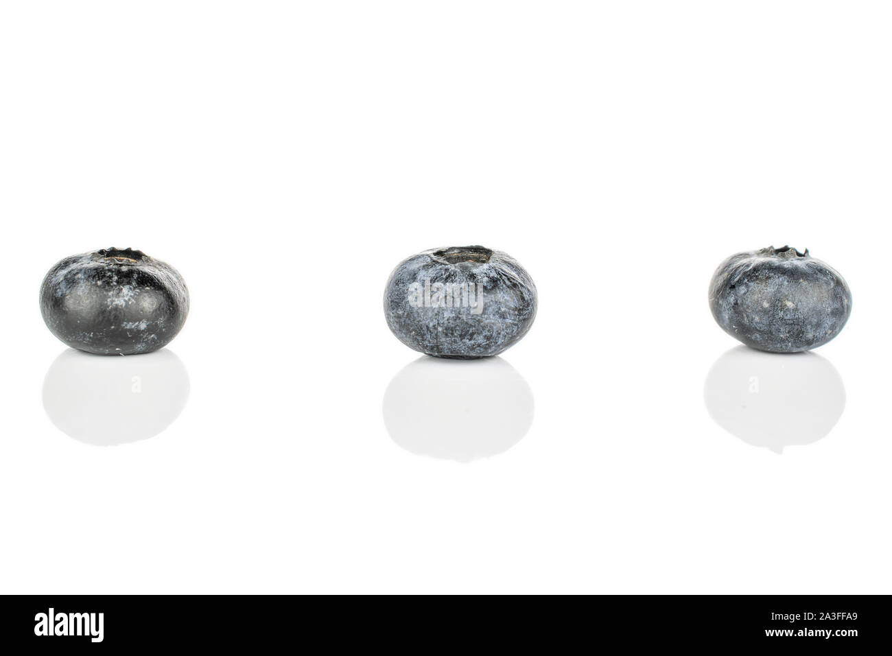 Group of three whole fresh blue blueberry isolated on white background ...