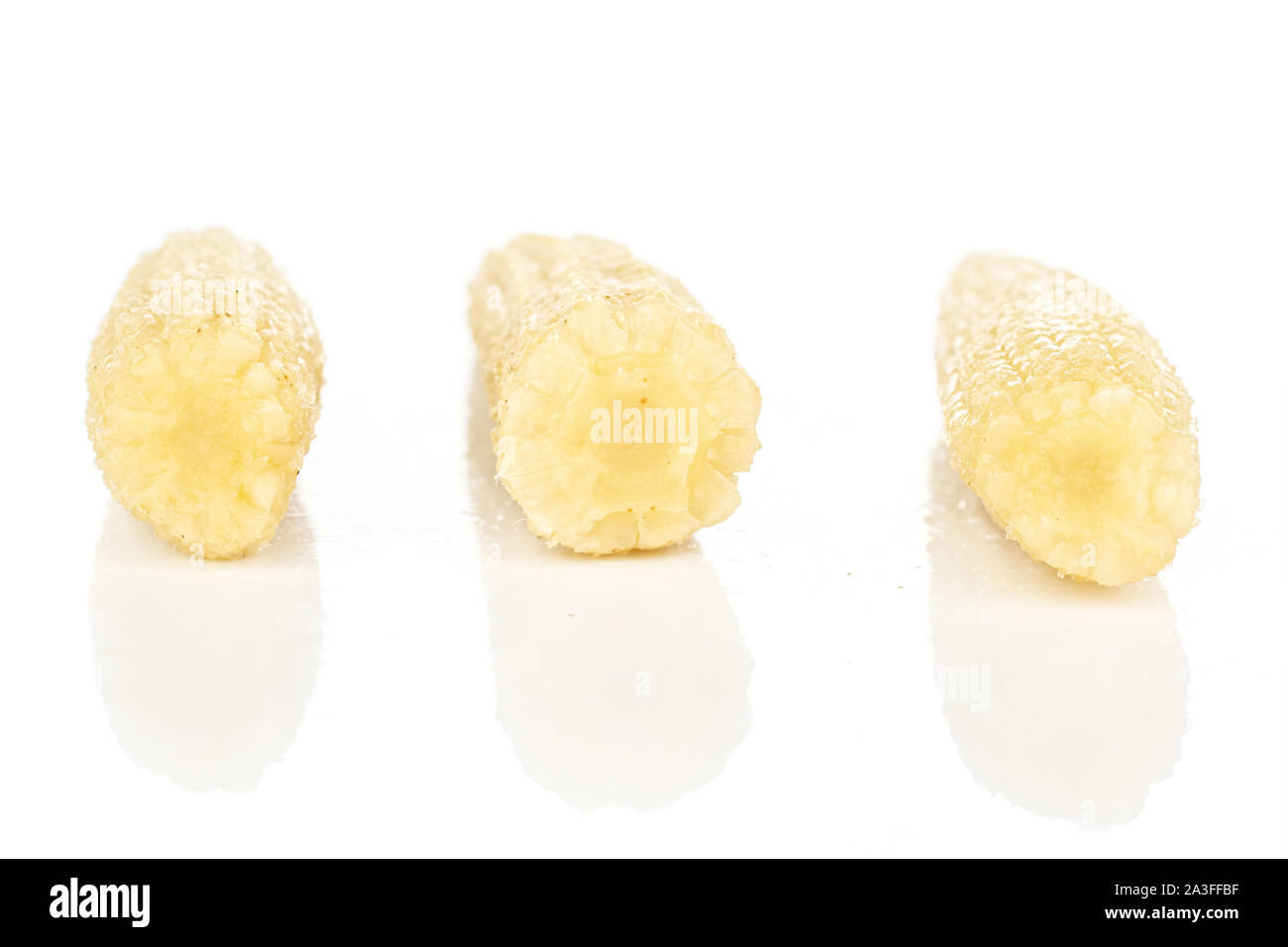 Group of three whole baby yellow corn isolated on white background ...