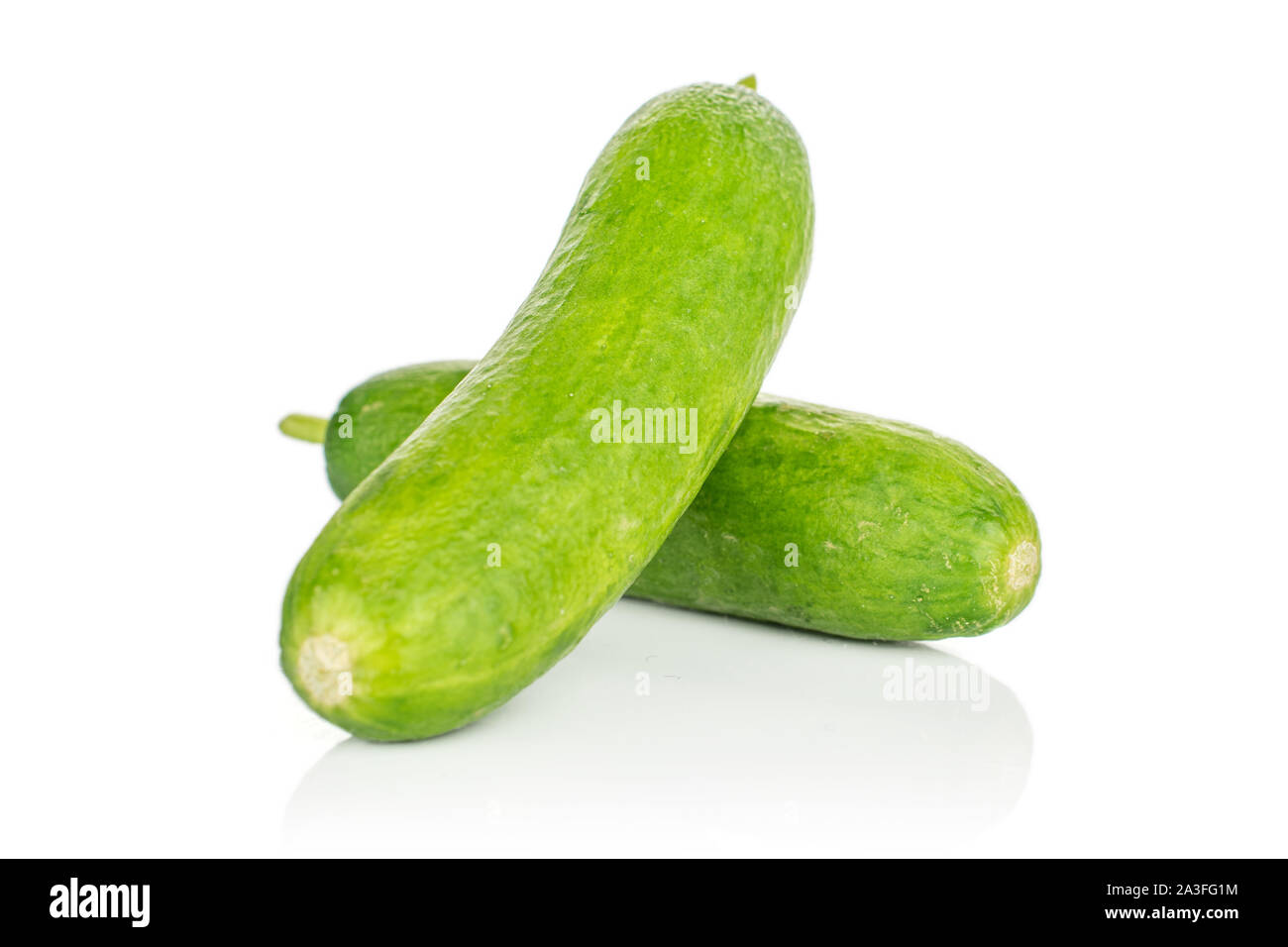 Group of two whole mini green cucumber isolated on white background ...