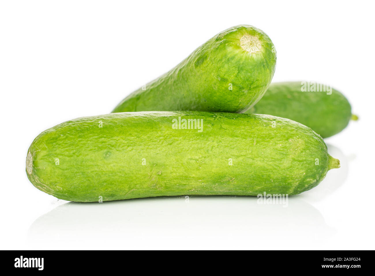 Group of three whole mini green cucumber isolated on white background ...