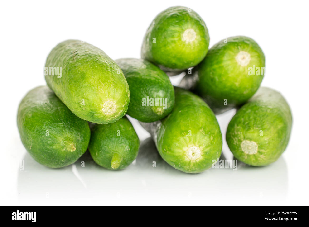 Group of seven whole mini green cucumber isolated on white background ...
