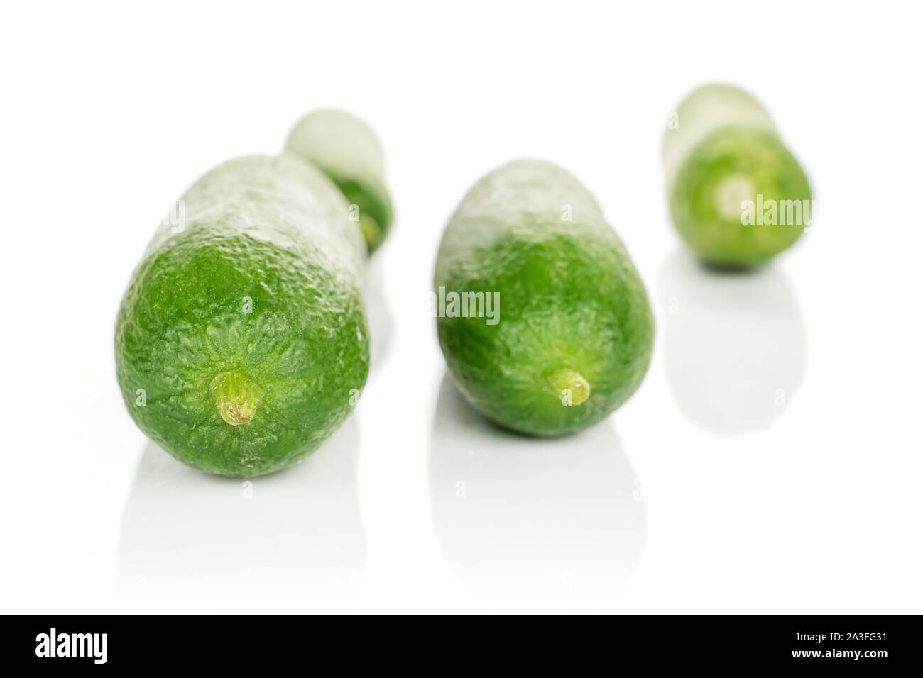 Group of four whole mini green cucumber isolated on white background ...