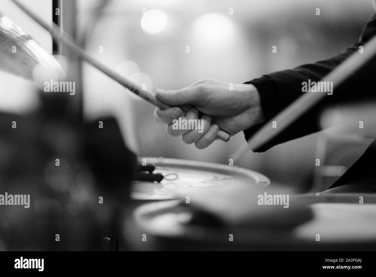 The musician's hand during performance of a composition on a drum set ...